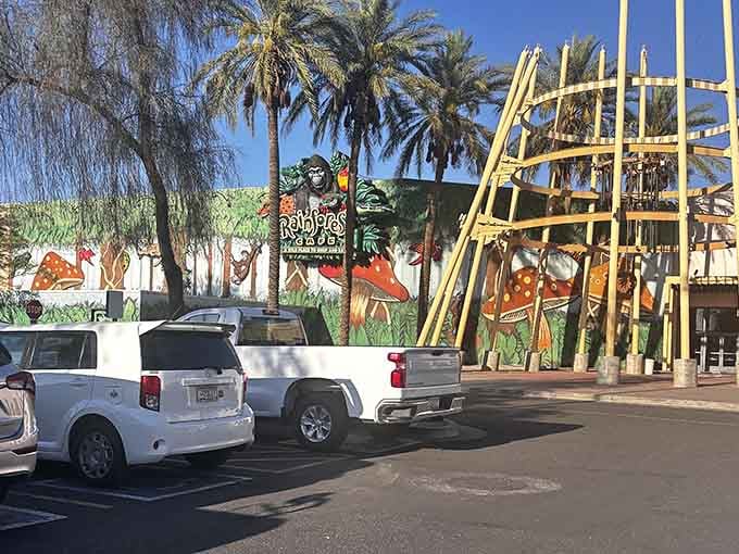 The exterior promises adventure with towering palm trees and jungle murals visible from the parking lot itself.