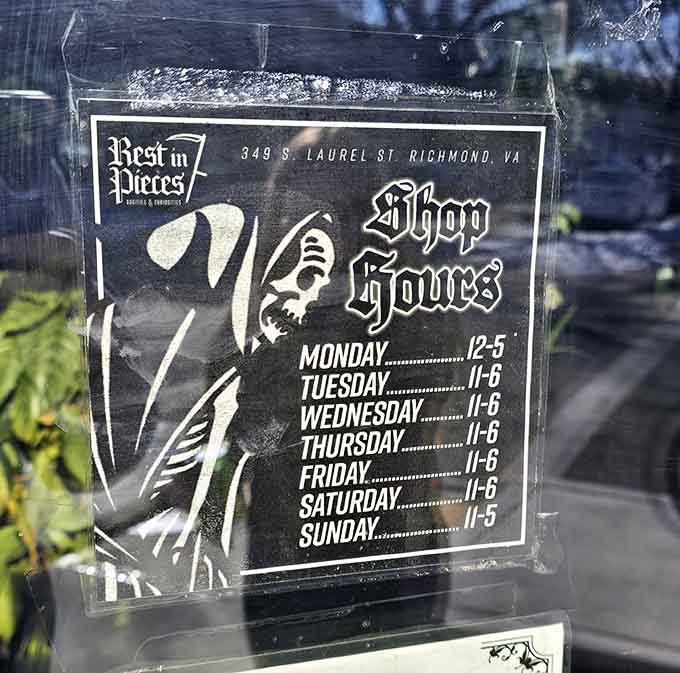 Shop hours posted on the door, because even perpetual Halloween needs structure and someone has to mind the skeletons.