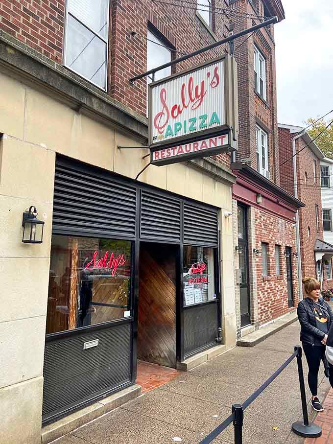 The entrance to Sally's Apizza, where lines form early and patience is rewarded with legendary coal-fired perfection.