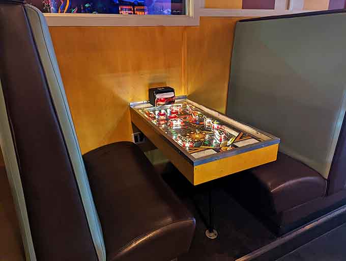 A pinball machine built into your booth means dinner and entertainment literally share the same table, genius incarnate.