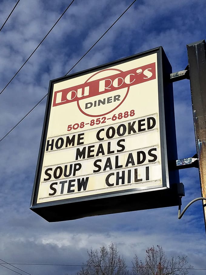 The roadside sign promises exactly what hungry travelers need: home-cooked comfort without pretense, standing tall against the Massachusetts sky.