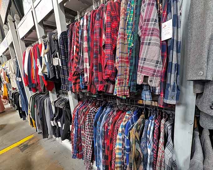 Rows of vintage flannel shirts hang like a lumberjack's dream closet, proving plaid never truly goes out of fashion.