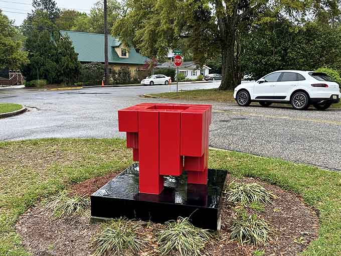 This oversized red chair sculpture invites you to sit like a giant contemplating your very small problems.