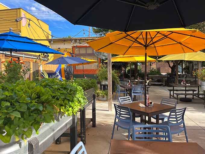 Patio dining under colorful umbrellas turns breakfast into an outdoor celebration of food, sunshine, and good decisions.