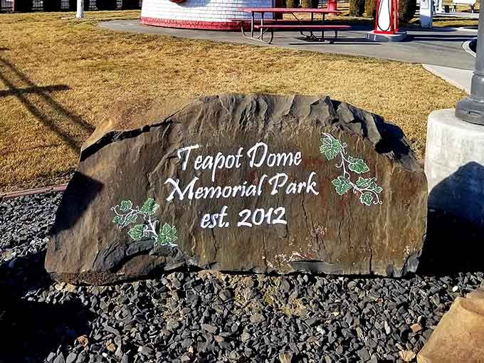 The memorial stone marks the park's establishment, celebrating the community's dedication to preserving this beloved architectural treasure.