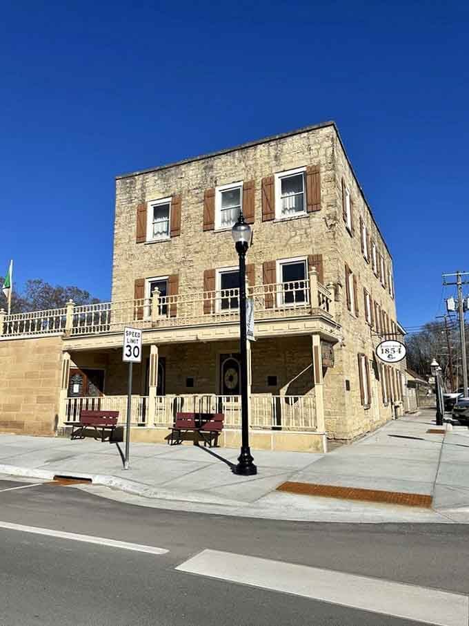 Corner view showing The Hubbell House commanding its intersection, a limestone landmark that's earned its place in Mantorville history.