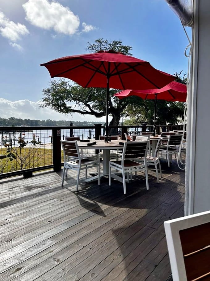 Outdoor deck seating overlooks the water, where dining becomes an event and every meal feels like vacation.
