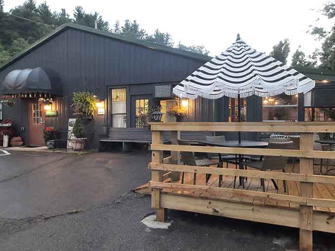 Evening lights twinkle on the deck, transforming this spot into a magical mountain dining destination.