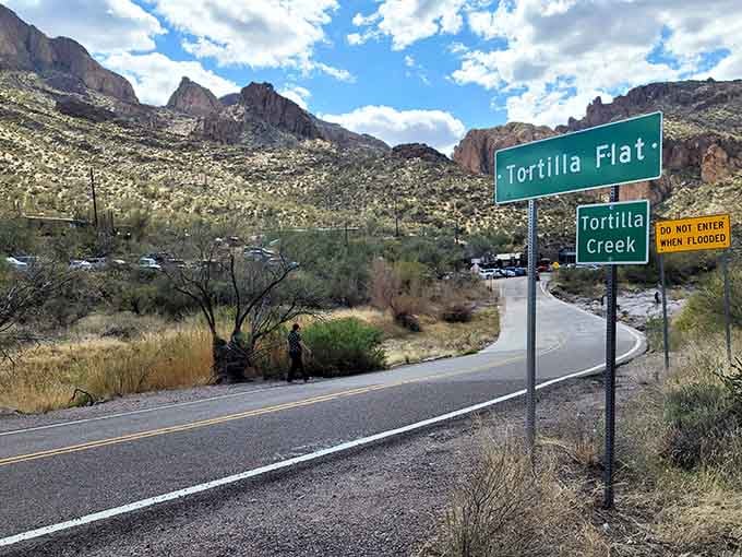 That green highway sign marking Tortilla Flat might be the most honest welcome you'll ever receive from any town anywhere.