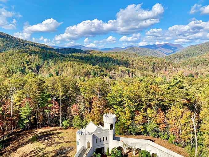 Autumn colors surround white castle turret proving Georgia's fall foliage rivals any European countryside scenery easily.