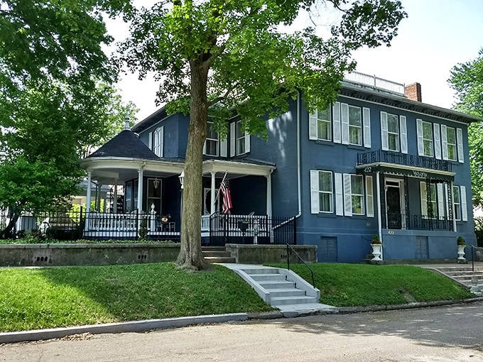 The stately Victoria Bed & Breakfast Inn offers a glimpse of 19th-century elegance, its blue exterior and welcoming porch promising comfortable respite.
