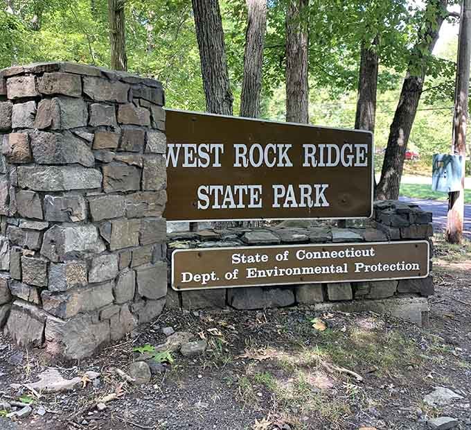 Welcome to West Rock Ridge State Park, where the sign promises adventures and the state guarantees environmental protection beautifully.