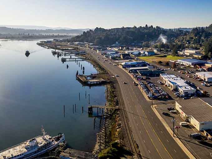 Aerial views reveal Coos Bay's working waterfront, where boats and industry coexist with the kind of authenticity cities have forgotten.