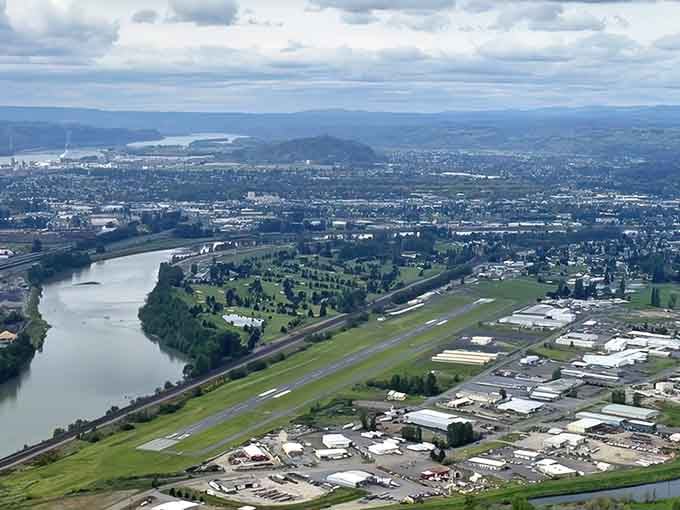 Rivers wind through green valleys below, revealing a town nestled perfectly between water, land, and endless Pacific Northwest sky.
