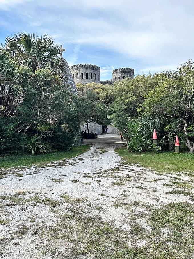 The path less traveled leads to unexpected treasure&mdash;a white shell driveway guiding visitors between palms and live oaks toward medieval towers.