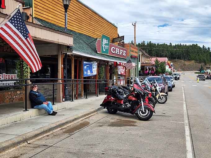 The American flag waves hello as motorcycles stand guard outside. In Hill City, even parking spots tell you you're somewhere special.