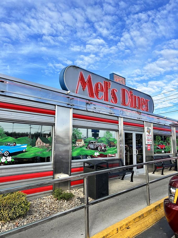 Under blue Tennessee skies, Mel's exterior mural tells stories of classic cars and country roads&mdash;a painted promise of the nostalgic feast waiting inside.