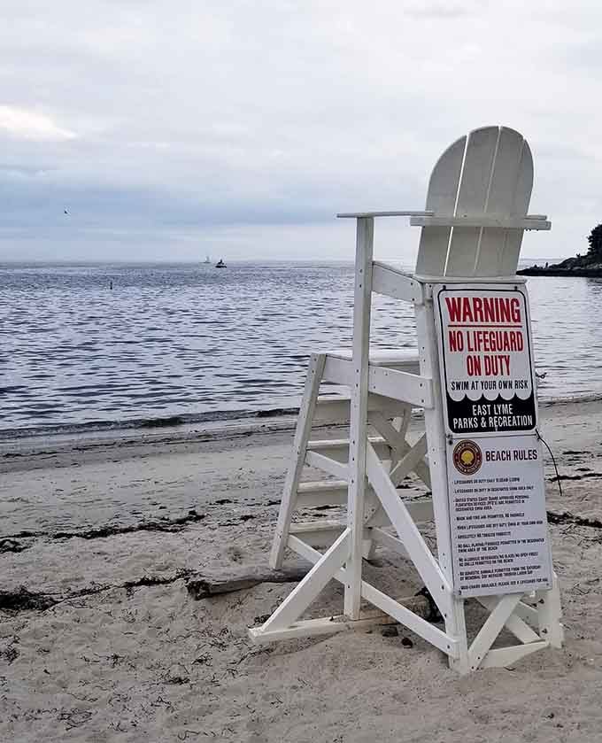 The empty lifeguard chair stands as both warning and invitation—the water beckons, but respect for the sea is non-negotiable.