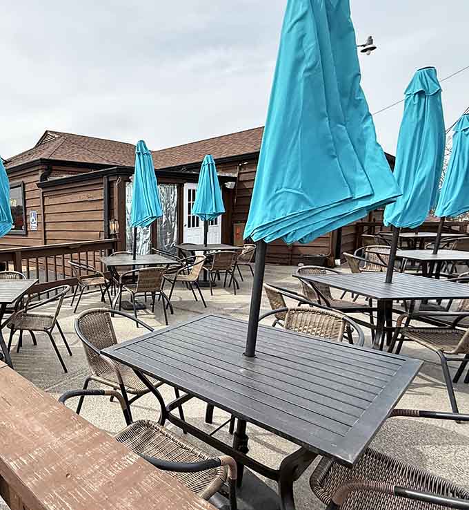 The outdoor patio stands ready with turquoise umbrellas&mdash;summer's perfect stage for enjoying comfort food under Missouri skies.