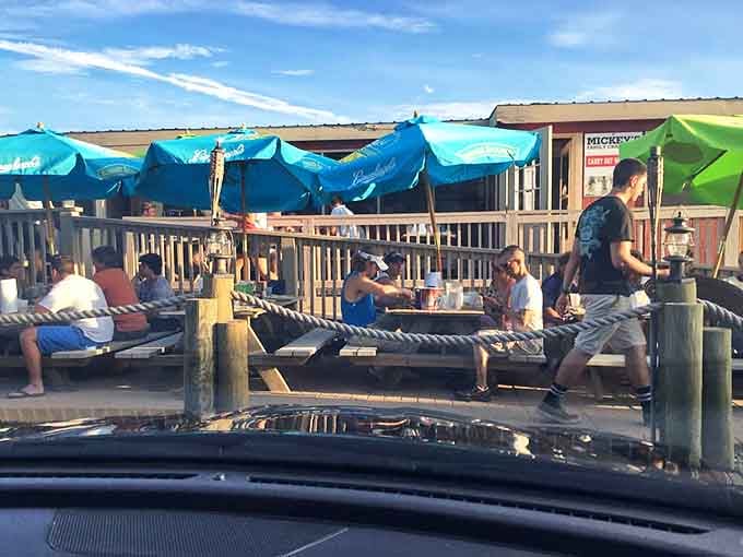 The outdoor deck at Mickey's isn't just a waiting area&mdash;it's prime real estate where the salt air enhances every sip and bite while you watch the world go by.