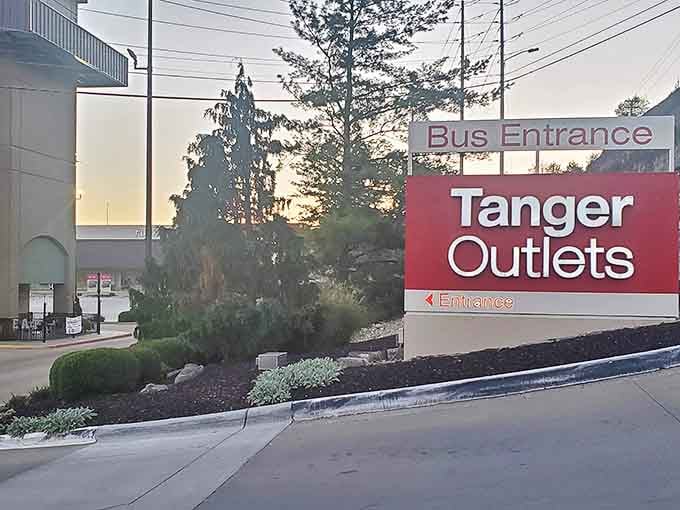 The Tanger Outlets sign at dusk marks both beginning and end &ndash; the alpha and omega of your shopping pilgrimage through the land of discounted retail dreams.