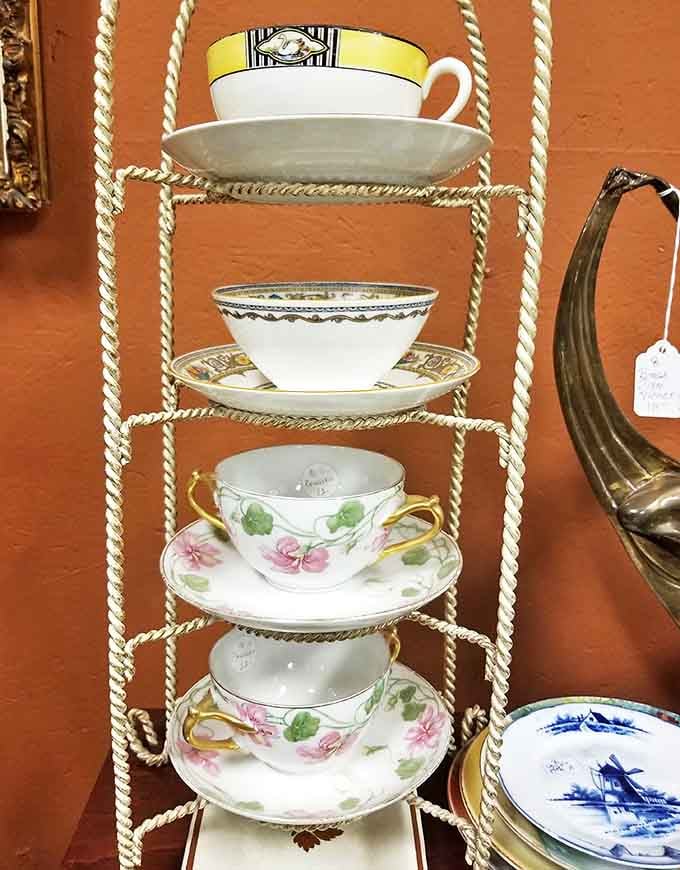 Delicate teacups stacked with precision remind us of an era when afternoon tea was an event, not just a beverage choice.