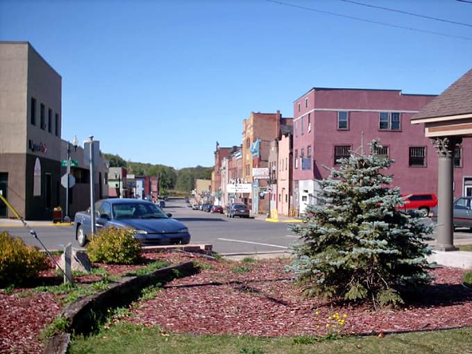 Historic storefronts march down the street in cheerful colors, each building telling its own story of community and commerce.