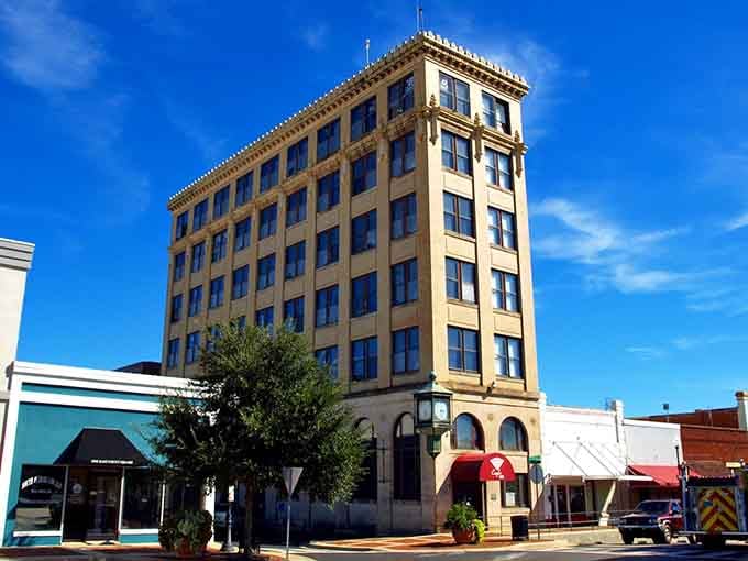 That tall building standing proud against blue skies tells you downtown Andalusia means business and beauty combined.