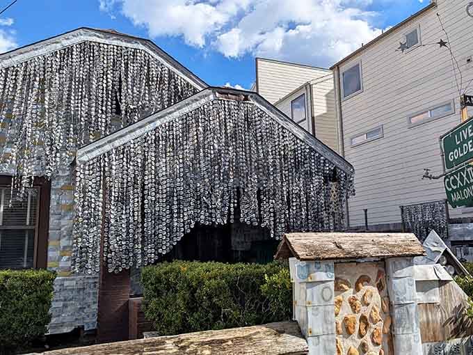 Those shimmering aluminum curtains cascading down create a metallic waterfall that catches sunlight like a disco ball.
