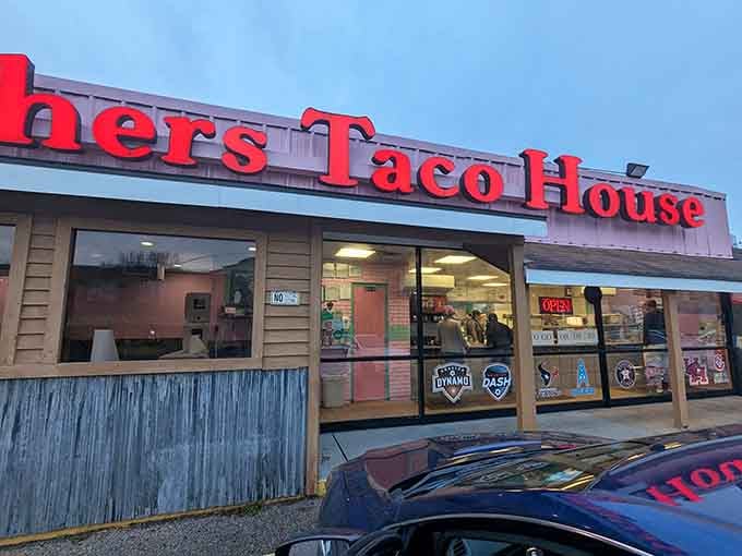 The iconic red sign of Brothers Taco House beckons hungry Houstonians like a breakfast beacon in the early morning light.