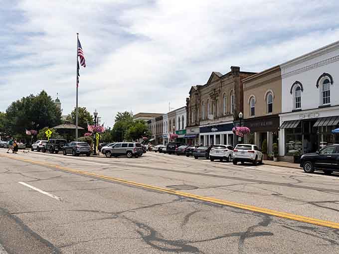 Classic Main Street America stretches before you, where historic storefronts and hanging flower baskets create pure nostalgia.