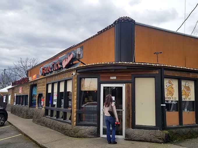 The orange facade of Fryer Tuck beckons like a crispy chicken lighthouse on a foggy day of hunger.