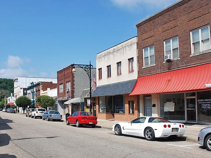 Classic brick storefronts and that cheerful red awning create a Main Street straight from your favorite memories.