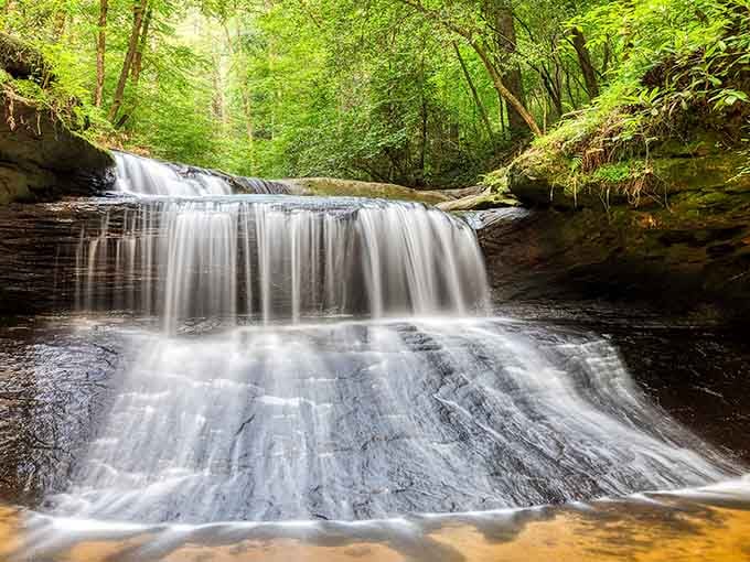 Nature's own staircase flows through lush forest, each tier more mesmerizing than the last.