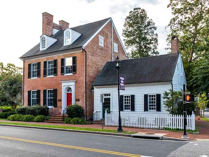 Colonial brick meets white picket fences in this postcard-perfect corner where history refuses to leave town.