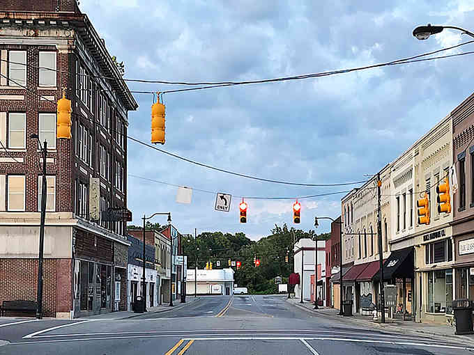 Picture this: Main Street America where traffic lights still dangle like Christmas ornaments year-round.