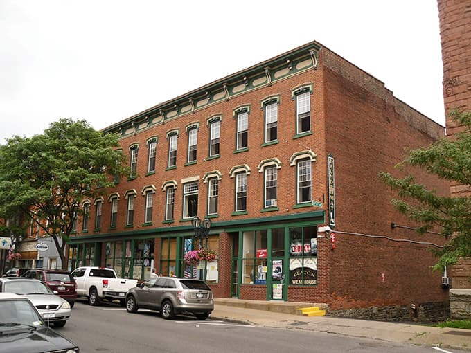 Classic brick buildings line these peaceful streets where hanging flower baskets add cheerful pops of color.