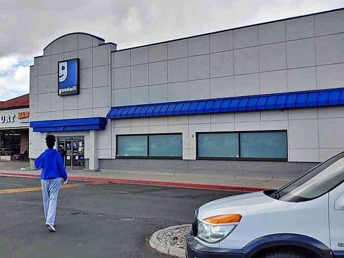 The iconic blue Goodwill sign beckons thrift hunters like a lighthouse for bargain treasures.