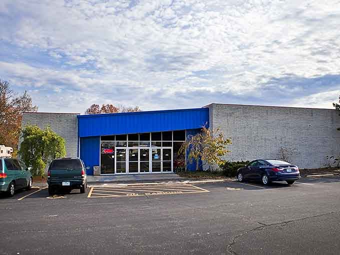 That bold blue awning beckons like a beacon for bargain hunters who know treasure awaits inside.