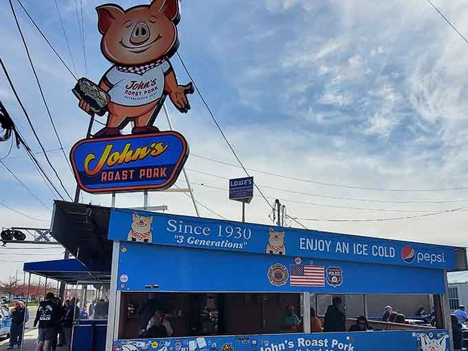 That cheerful pig mascot towering above the blue stand knows exactly what he's guarding: legendary roast pork sandwiches.