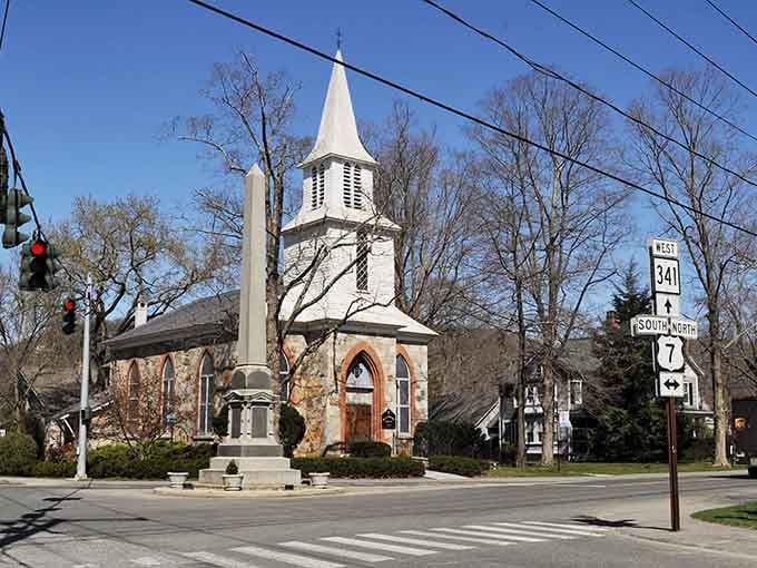 That stone church with its white steeple stands like a postcard from another era, pure New England magic.