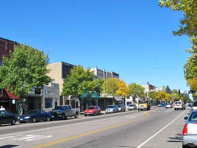 Golden autumn trees frame this peaceful main street where parking spots outnumber the stress in your life.