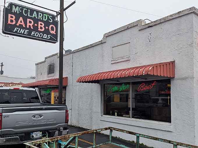McClard's Bar-B-Q sign stands as a beacon of hope for hungry travelers. That weathered neon promises smoky delights that have kept this joint legendary for generations.