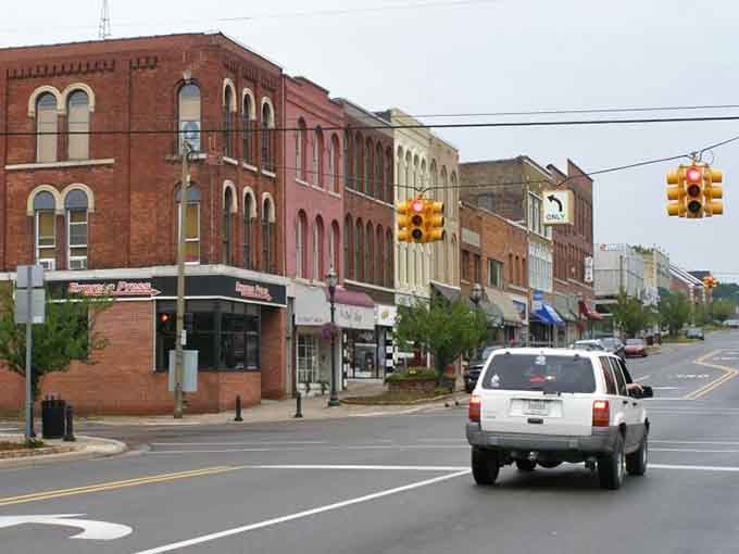 Classic brick storefronts line these quiet streets where your morning coffee costs what it should, not a fortune.