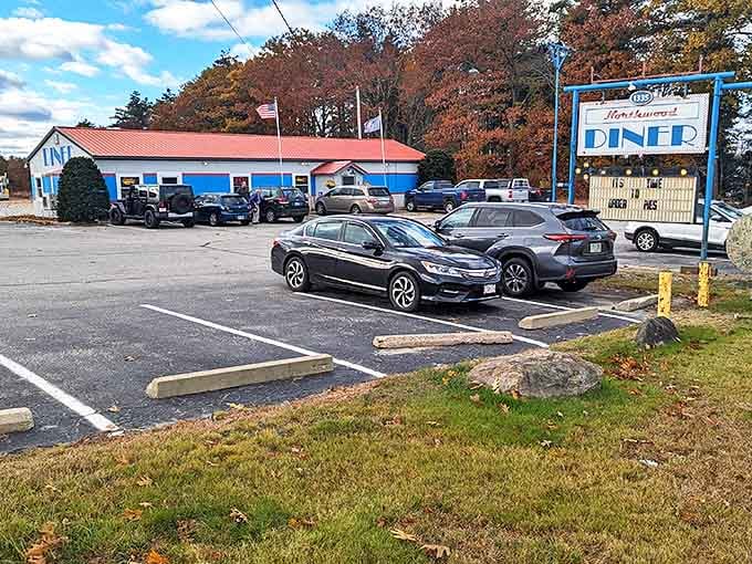 The Northwood Diner stands proudly against autumn foliage, its blue exterior and vintage sign promising comfort food that'll make your soul smile.