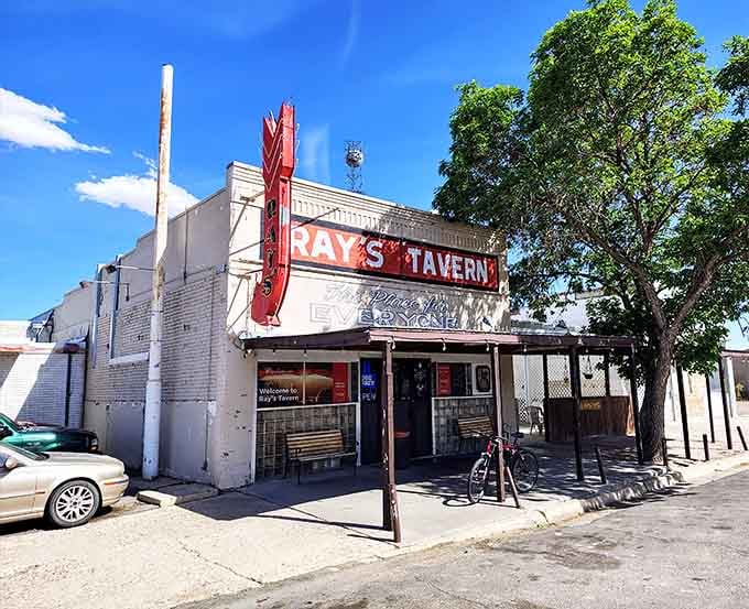 Ray's Tavern stands like a weathered cowboy, promising hearty meals and honest hospitality in Green River's desert landscape.