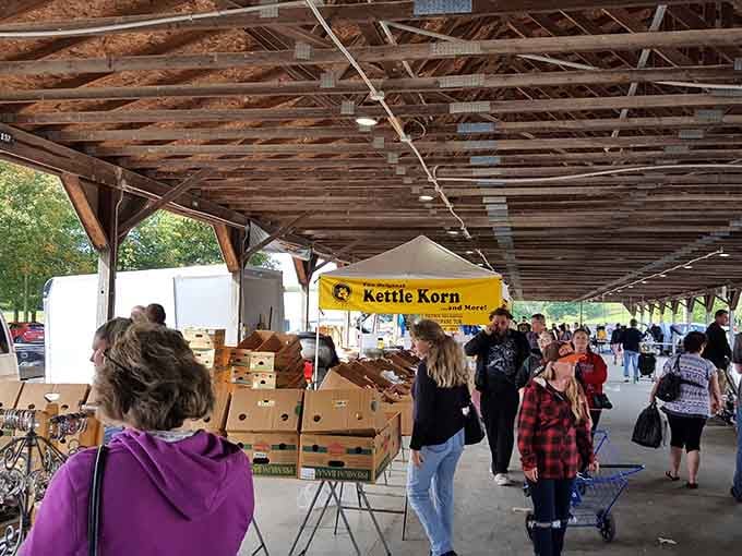 That weathered wooden pavilion shelters treasures like fresh produce and vintage finds waiting to be discovered.