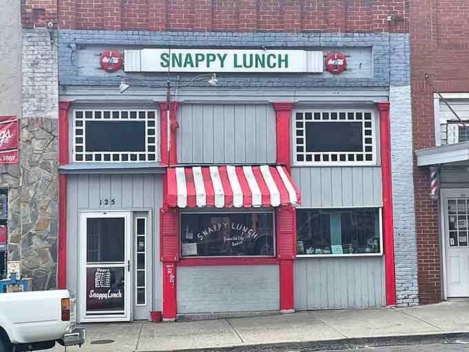 That red and white striped awning beckons like a candy cane, promising pork chop sandwiches worth the wait.