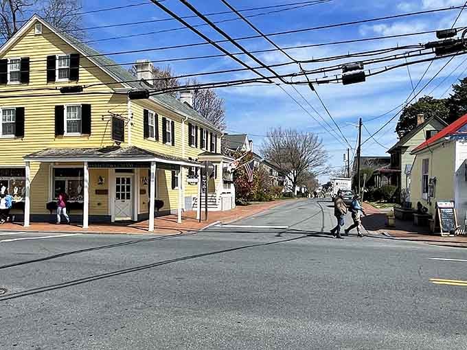 That cheerful yellow building practically glows with welcome, like a lighthouse guiding you to small-town charm and good times.