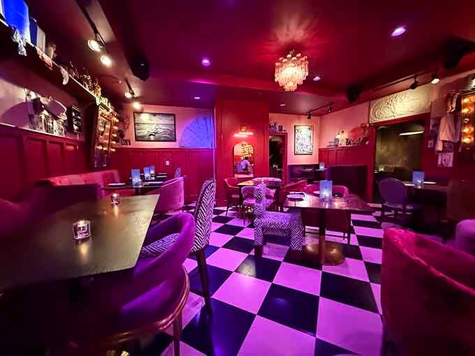 Purple velvet and checkerboard floors create a dining room that looks like Prince designed a supper club.